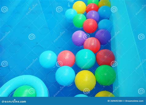 Creative Image Of A Bunch Of Colorful Plastic Balls Floating In A