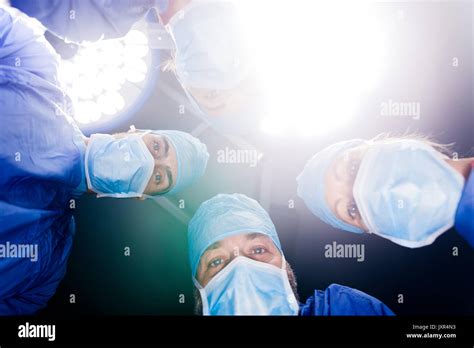 Team Of Doctors Looking Down At Patient In Operation Room Surgeons