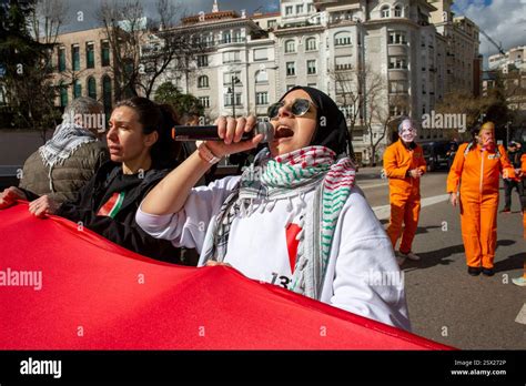 A Protester With A Kufiya Around Her Neck Shouts Slogans On A