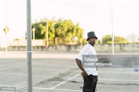 Young Cool Black Male In A Street Style Outfit Posing In An Empty