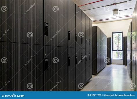Black Wooden Locker Room At The Far End Is A Glass Window There Is A Tree Outside Stock Image