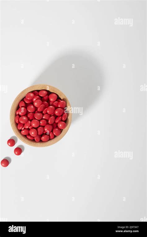 Red Chocolate Candy Pills In Bowl Isolated On White Background Stock