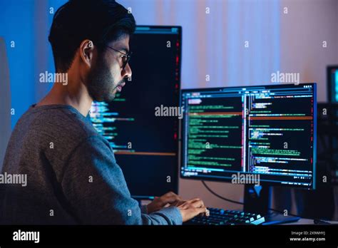 Indian Software Development Working On Coding Computer Screen And Flowchart At Night In Modern