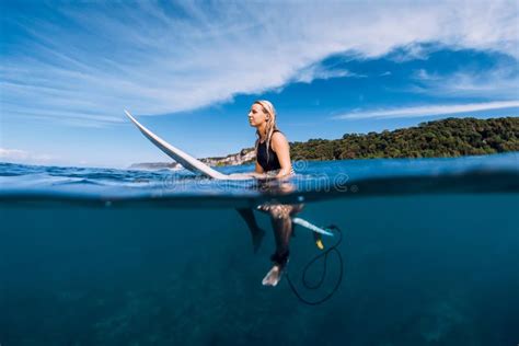 Surfer Girl With Surfboard Relaxing At Line Up In Ocean Stock Image