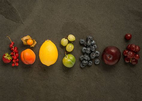 A Selection Of Colourful Fruits Arranged In Rainbow Colours On A