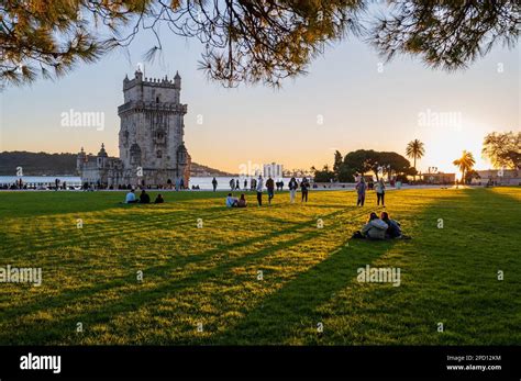 People Enjoying Belen Tower Garden Jardim Da Torre De Belem At Sunset