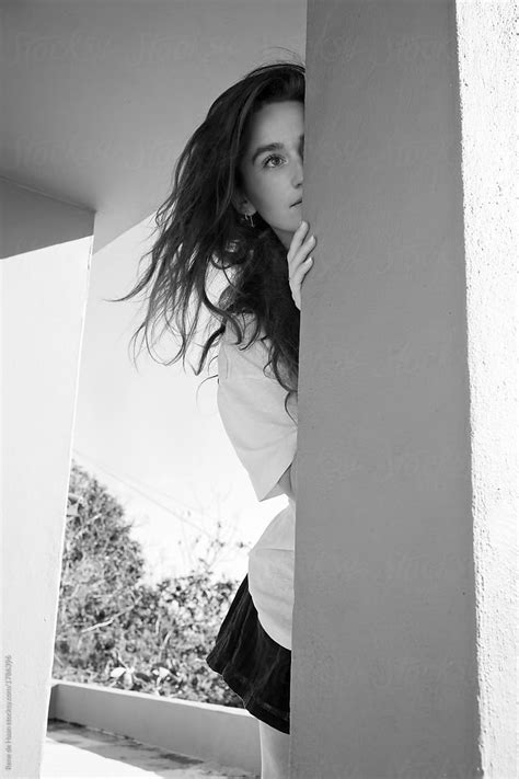 Young Woman Hiding Behind Wall By Stocksy Contributor Rene De Haan