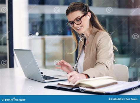 Shes A Busy Bee As Always A Young Businesswoman Wearing Earphones