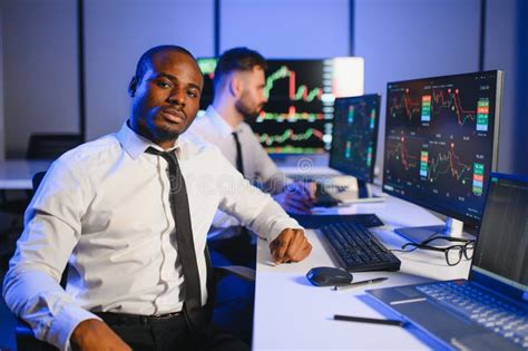 Financial Analyst Working On Computer With Multi Monitor Workstation