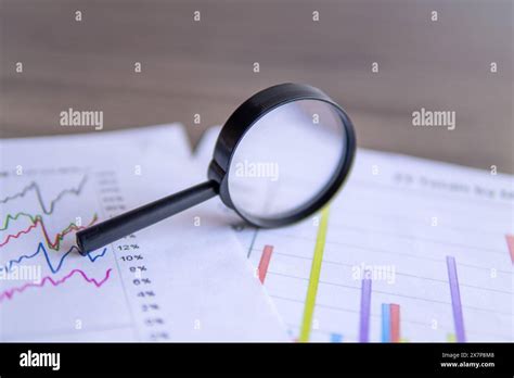A Magnifying Glass On A Bar Graph And Line Graph Business And Finance