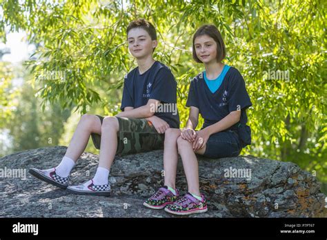 Outdoor Setting Of Yeard Old Brother And Yead Old Sister Posing