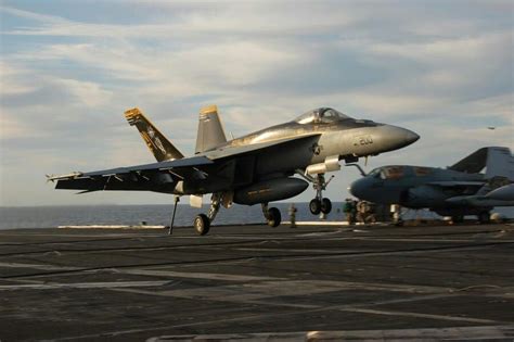 Hook Down Fa 18e Super Hornet Landing Over An Aircraft Carrier