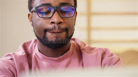 Portrait of Focused Black Man with Eyeglasses Working with Computer, Professional Programmer ...