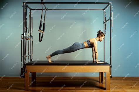 Premium Photo Young Girl Doing Pilates Exercises With A Reformer Bed