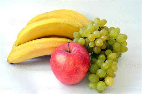 Big Red Apple In Front Of The Bunch Of Bananas And Ripe Indian Green