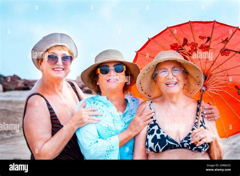 Group Mature Women Wearing Beach Hats And Smiling While Standing On A