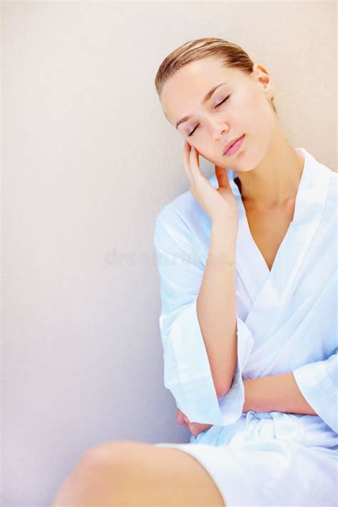 Female In A Bathrobe Fallen Asleep Against A Wall Cute Young Woman In