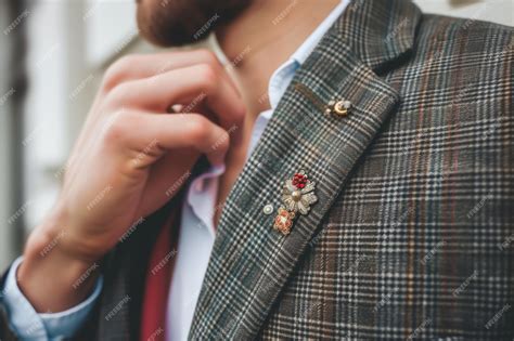 Premium Photo Man Showing Off A Bohostyle Lapel Pin On A Blazer