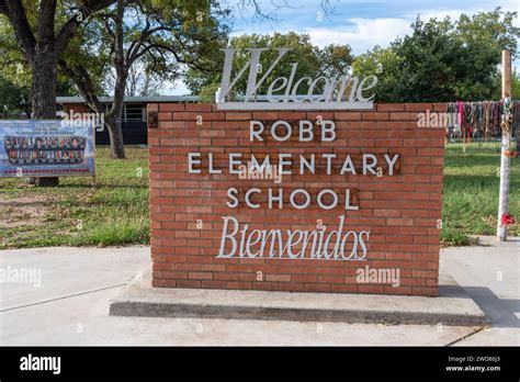 Welcome Sign In Front Of Robb Elementary School Memorial In Background