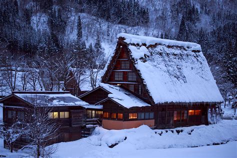 Traditional Japanese Home With Steep Peaked Roof In The Snow Near