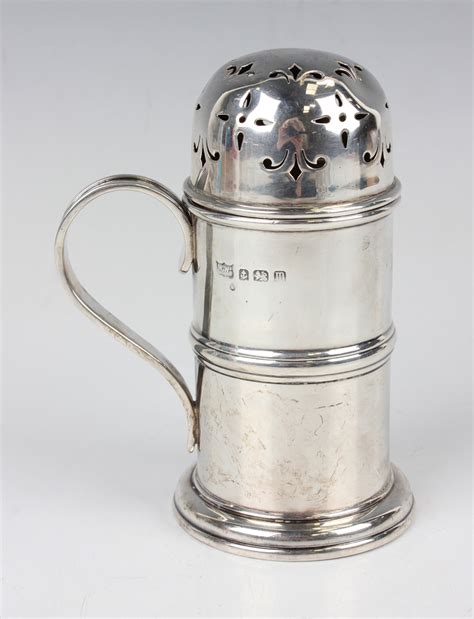 A George V Silver Flour Dredger Of Girdled Cylindrical Form With Loop Handle And Pierced Dome Cover