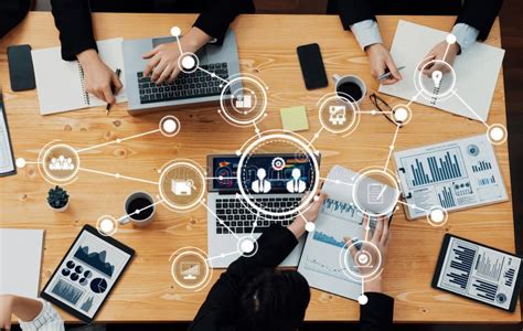 Collaborative Business Meeting With Laptops And Digital Graphics On