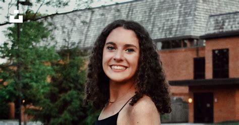 Woman In Black Spaghetti Strap Top Standing On Green Grass Field During