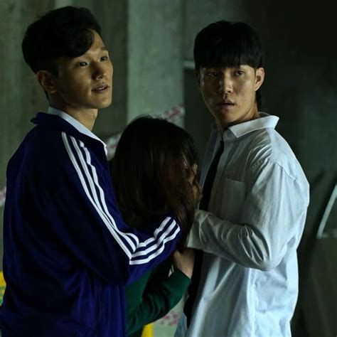 Two Men And A Woman Standing Next To Each Other