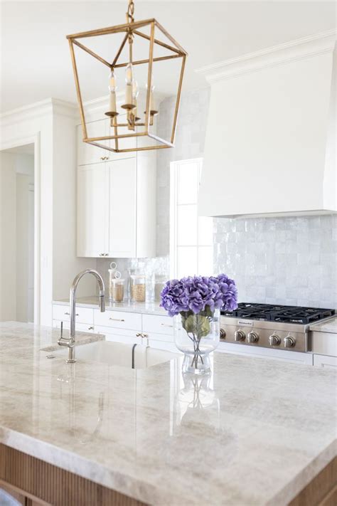 White Kitchen With Marble Countertops And Oak Floors