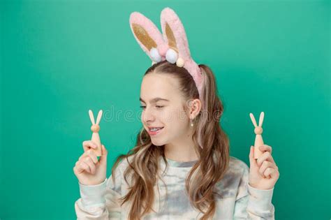 Girl With Joyful Smile Wearing Glittery Pink Bunny Ears Holding Wooden