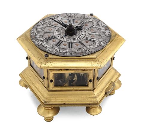 C1700 A Small Gilt Brass Hexagonal Horizontal Table Timepiece With