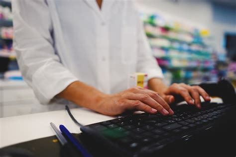 Premium Photo Pharmacist Woman Works At Computer At The Pharmacy Counter