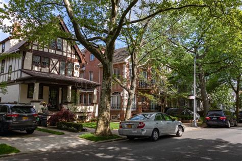 Row Of Beautiful Old Neighborhood Homes Along A Street With Green Trees