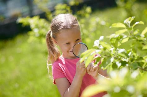Premium Photo Pretty Blonde Girl With Investigating Nature With A Magnifier