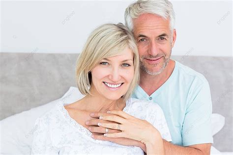 Mature Couple Sharing Love And Intimacy In Bed Photo Background And