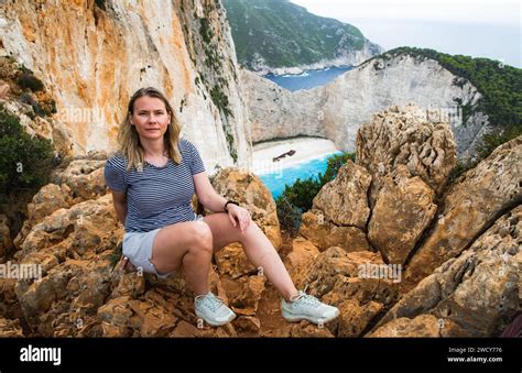 Woman Looking At Navagio Beach With The Famous Wrecked Ship In Zante