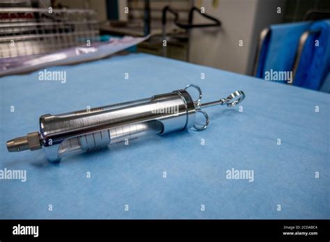 An Assembled Urological Bladder Syringe Lies On A Blue Surgical Base