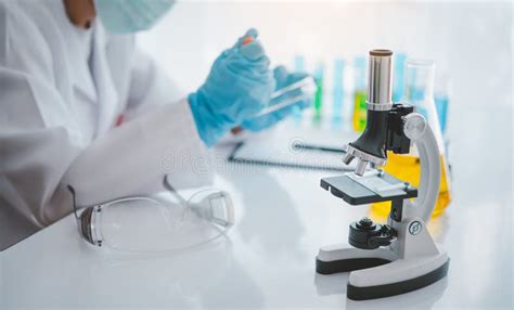 Female Researchers Are Experimenting With Pipette Dropping A Sample