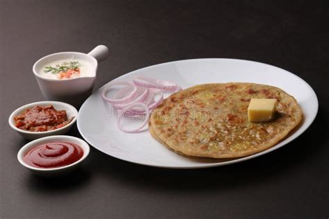 Traditional Indian Food Aloo Paratha Or Potato Stuffed Flat Bread Served With Pickle Stock
