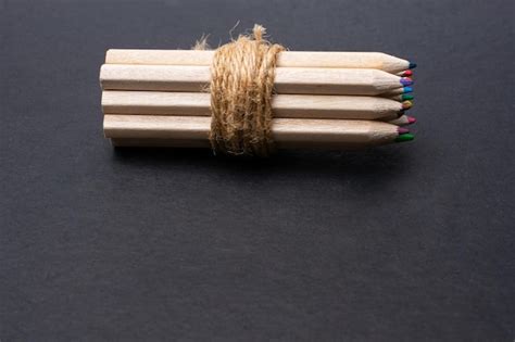 Premium Photo Bundle Of Colored Pencils Wrapped With Linen String