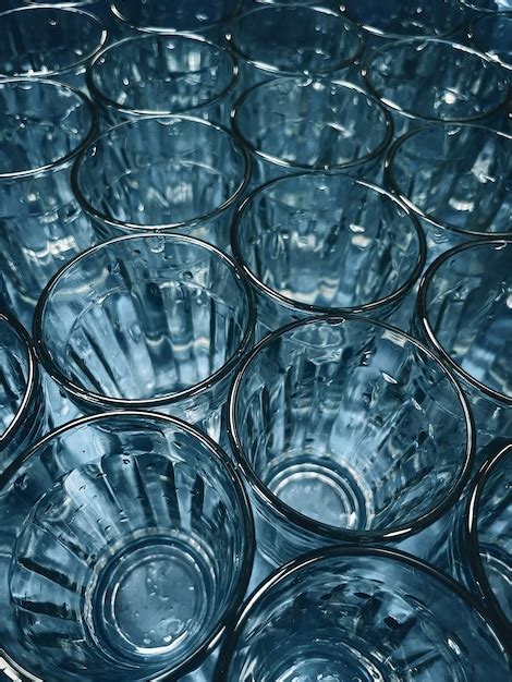 Premium Photo A Stack Of Empty Glasses On A Blue Table