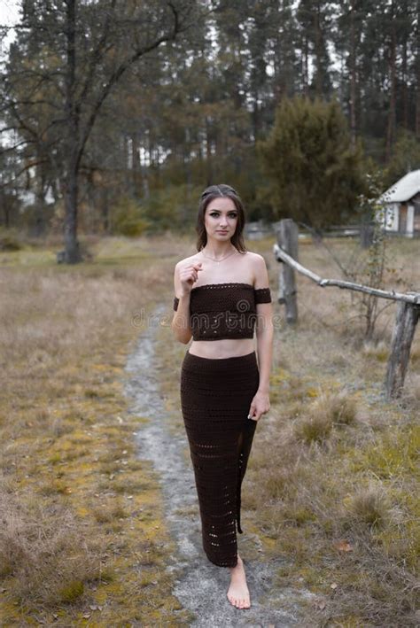 Barefoot Woman Walks On A Forest Path In A Beautiful Evening Dress