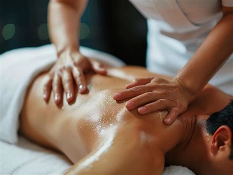 Massage Therapist Applying Oil During Back Massage In Spa Setting