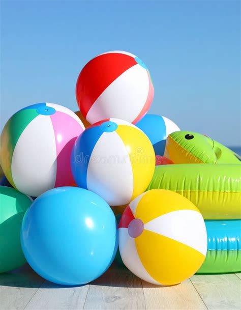 A Stack Of Colorful Beach Balls And Inflatable Toys Neatly Piled Ready