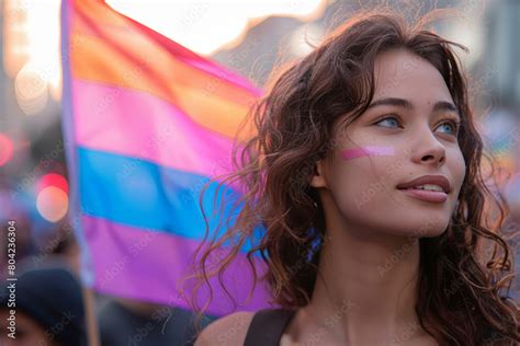 Individual Proudly Wearing Bisexual Pride Flag At A Parade With A