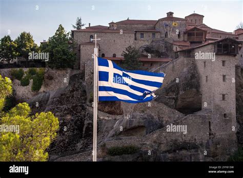The Greece Flag In Front Of The Holy Monastery Of Great Meteoron The Transfiguration Of Jesus