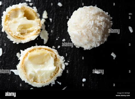 Close Up Of Broken Raffaello White Candy With Coconut Flakes On A Slate Dark Background Stock