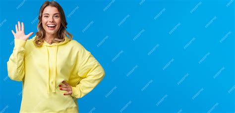 Free Photo Cheerful Friendly Outgoing Blond Girl Waving Hand Informal Greeting Concept Smiling