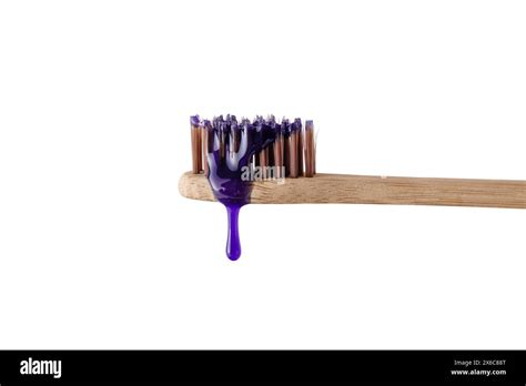 Swatch Of Whitening Purple Toothpaste On Wooden Toothbrush Isolated On