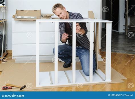 The Man Assembles The Furniture At Home Stock Image Image Of